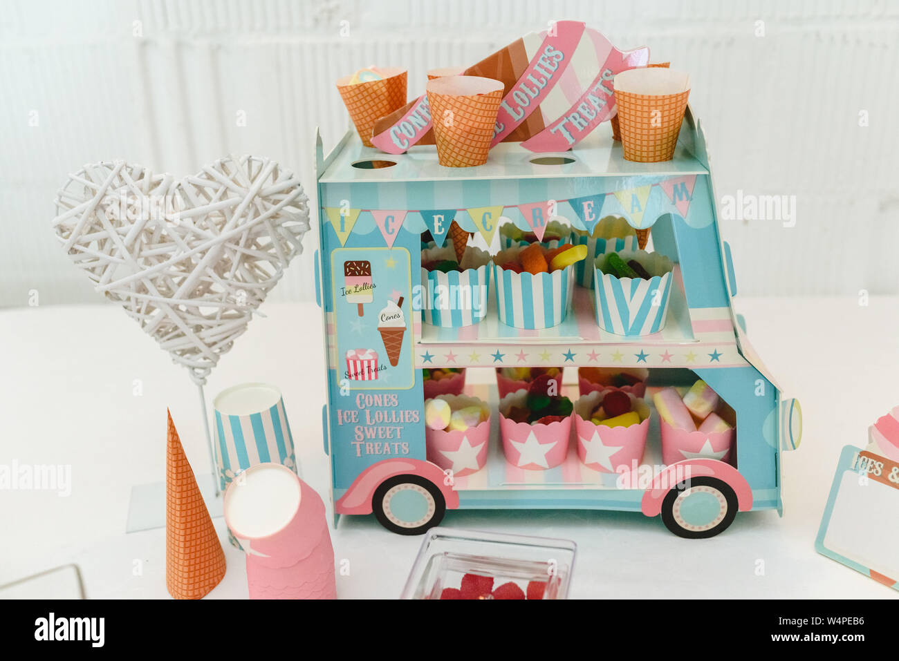 Candy bar shaped like a bus, decorated with pink tones Stock Photo - Alamy