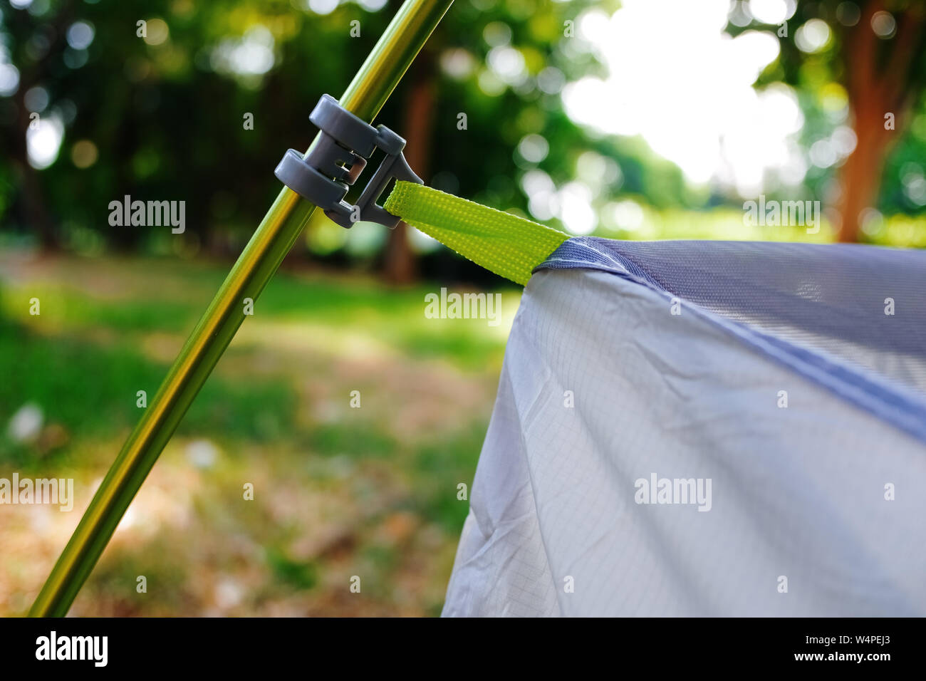 Setting up a modern tent, detail of the tensioners that support the ...
