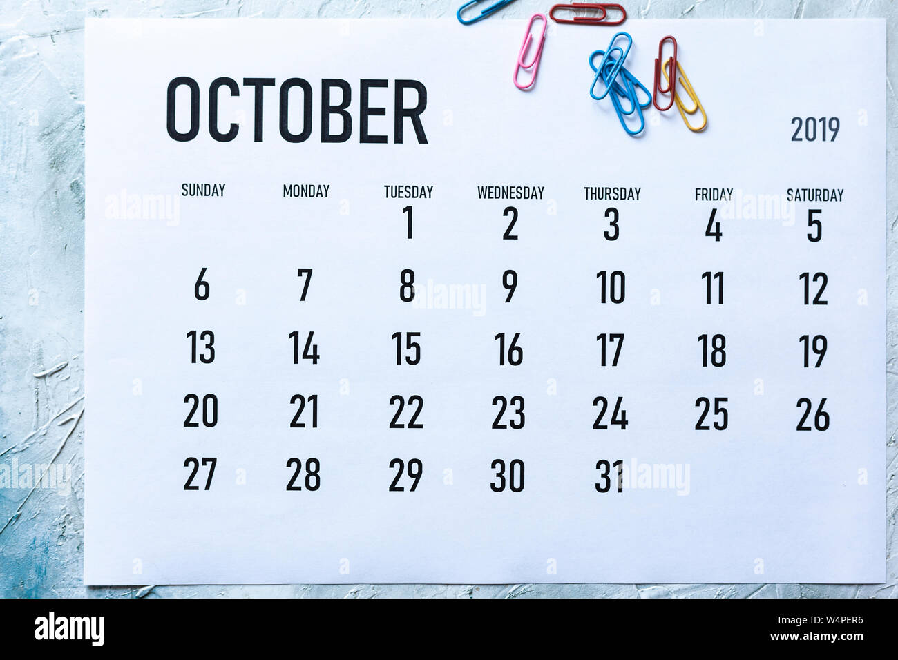 Simple 2019 October monthly calendar on table with office supplies ...