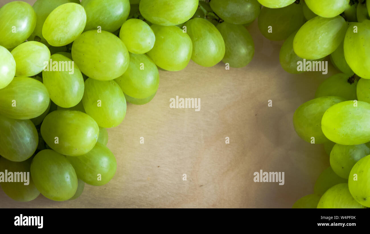Green grapes on top of wooden textural surface. Copy space Stock Photo ...