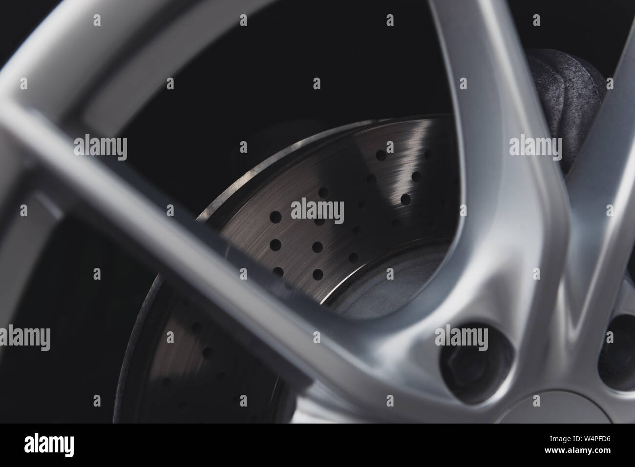 Gray metal sports car wheel. Closeup of a ventilated big brake disk ...