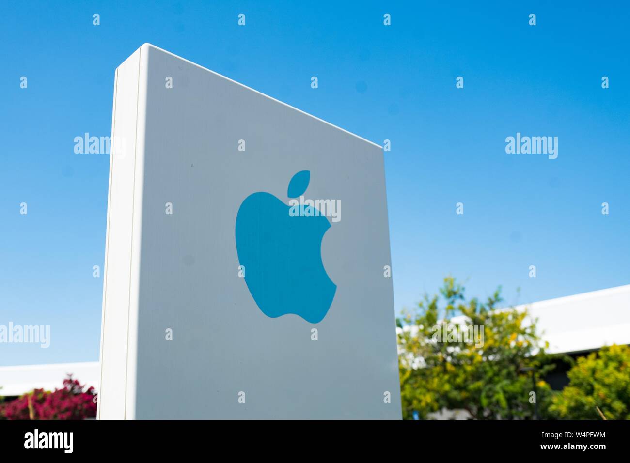 Close-up of blue logo on sign with facade of headquarters buildings in ...