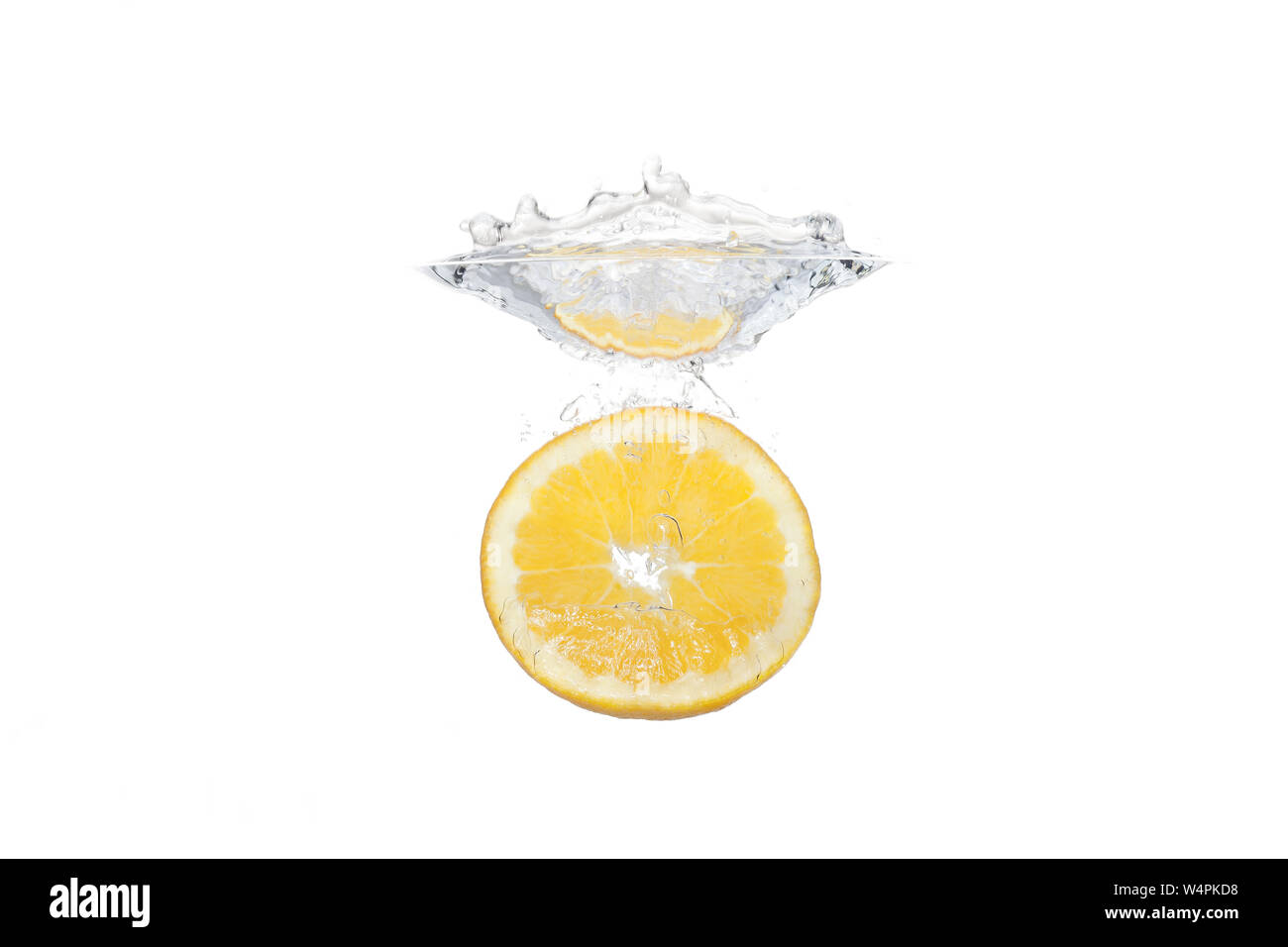 Fresh fruit dropped into water with splash on white background Stock ...