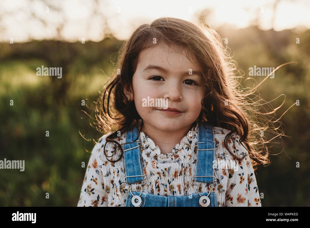 Portrait of young school-aged girl with sunlight in her hair Stock ...