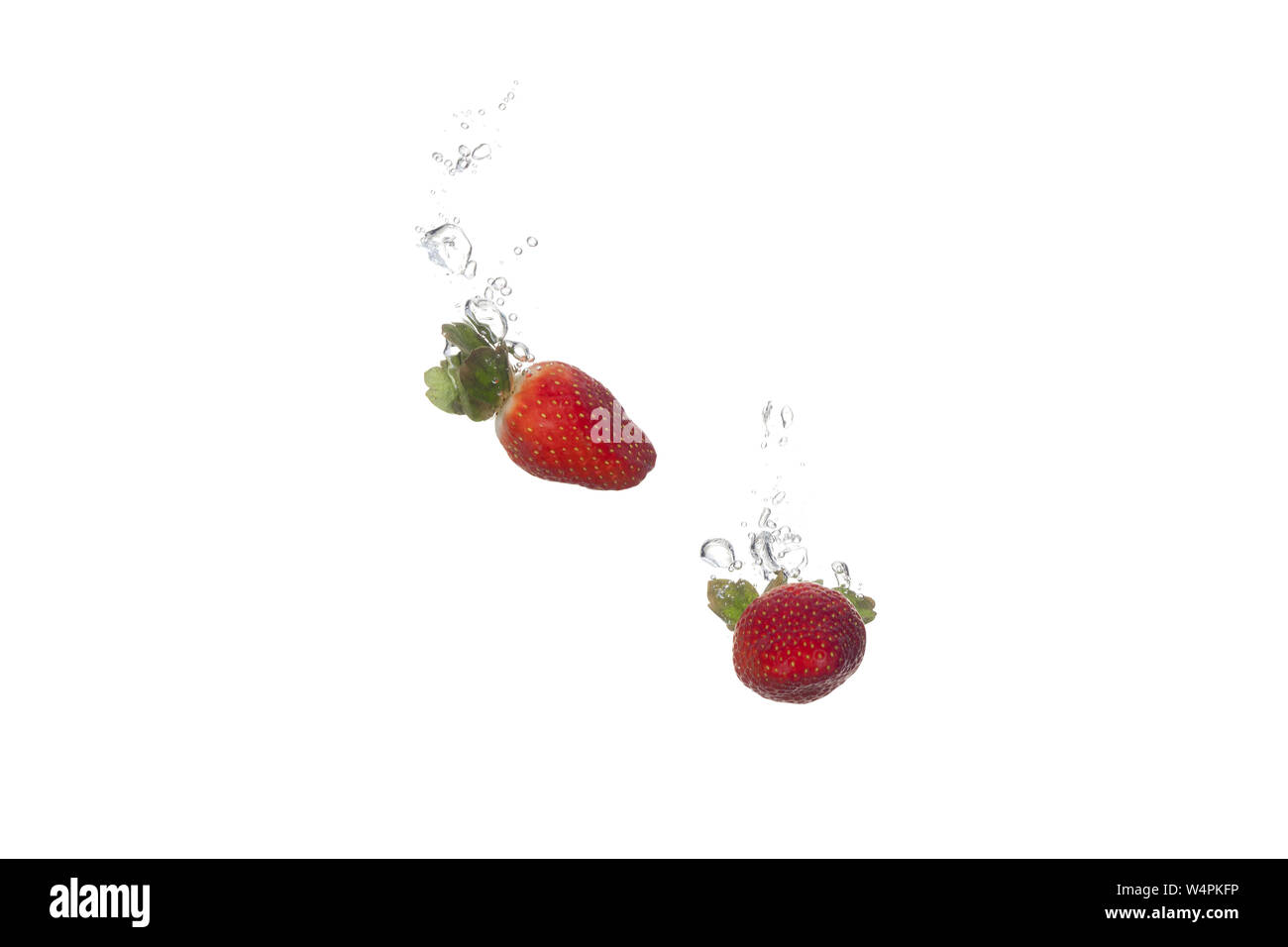 Fresh fruits dropped into water with splash on white background Stock ...
