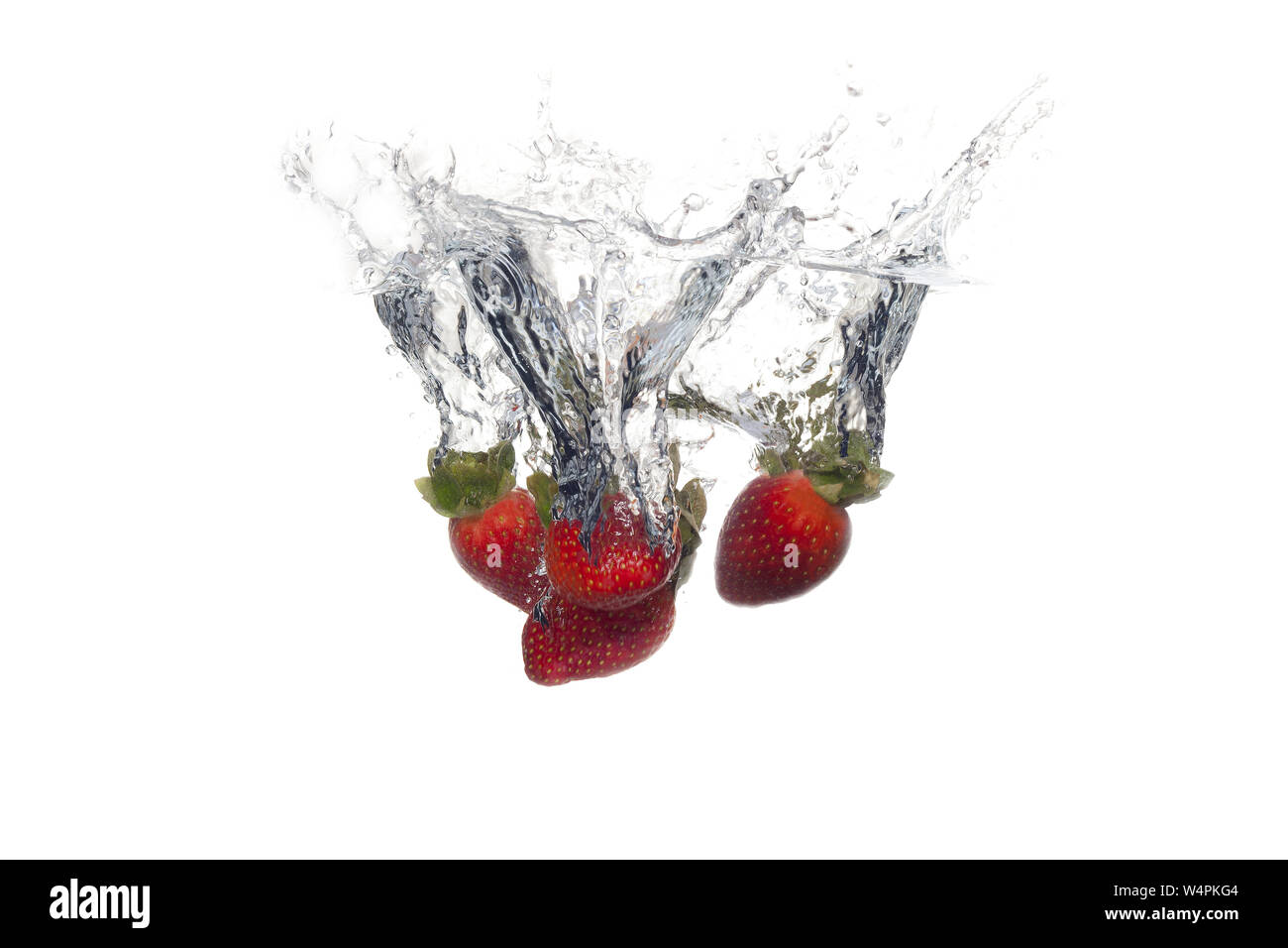 Fresh fruits dropped into water with splash on white background Stock ...