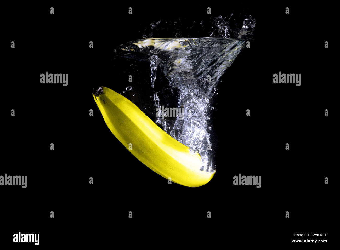 Banana droped into water with splash on black background Stock Photo ...