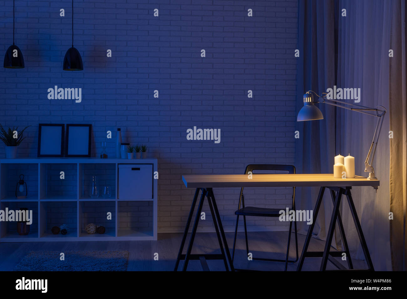 Lamp and work desk at night, overtime concept Stock Photo - Alamy