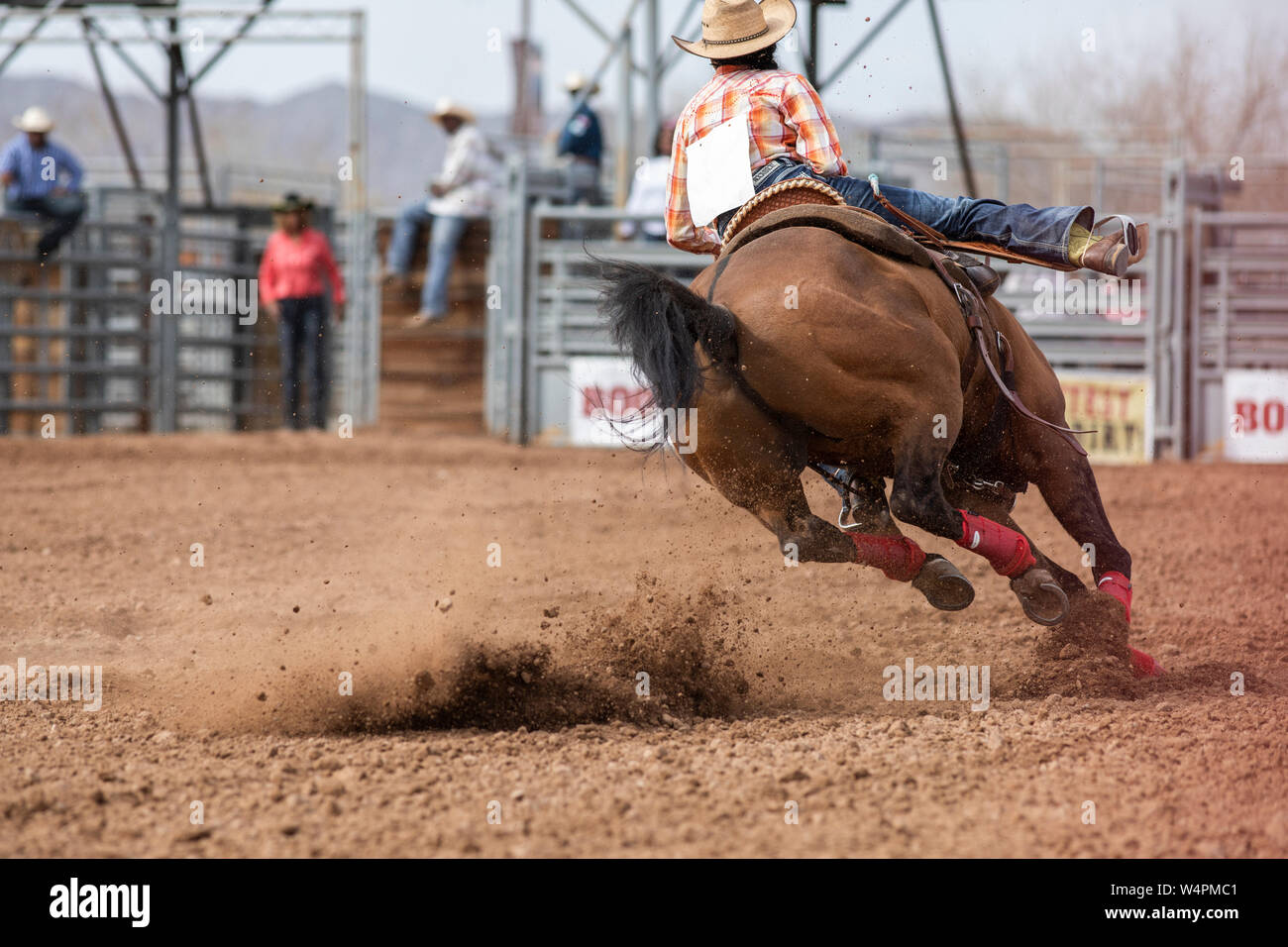 A female rider competes in the barrel racing event at the black rodeo ...