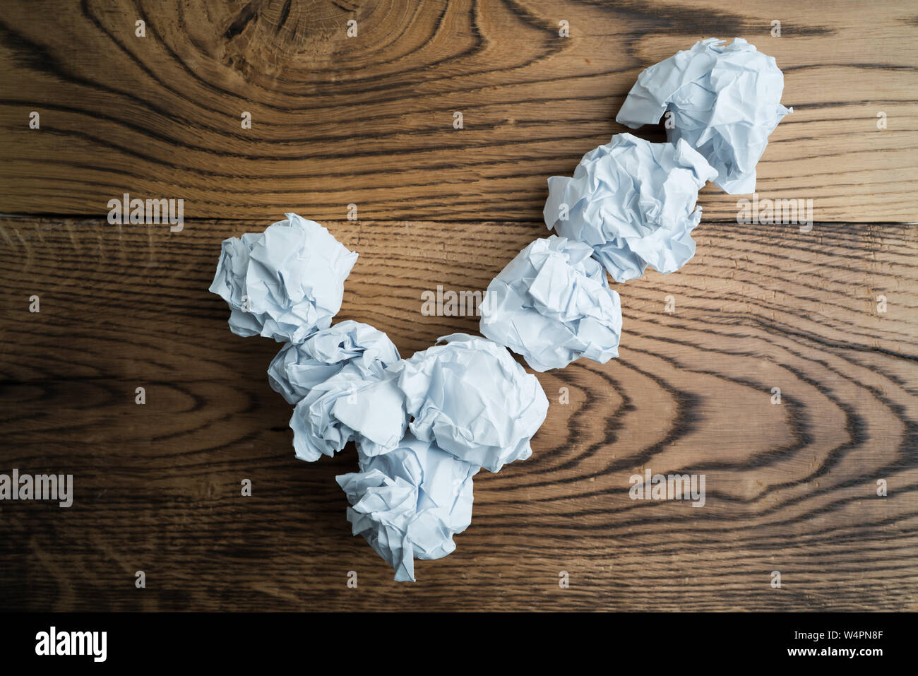 crumpled paper symbolizing different solutions forming a checkmark ...