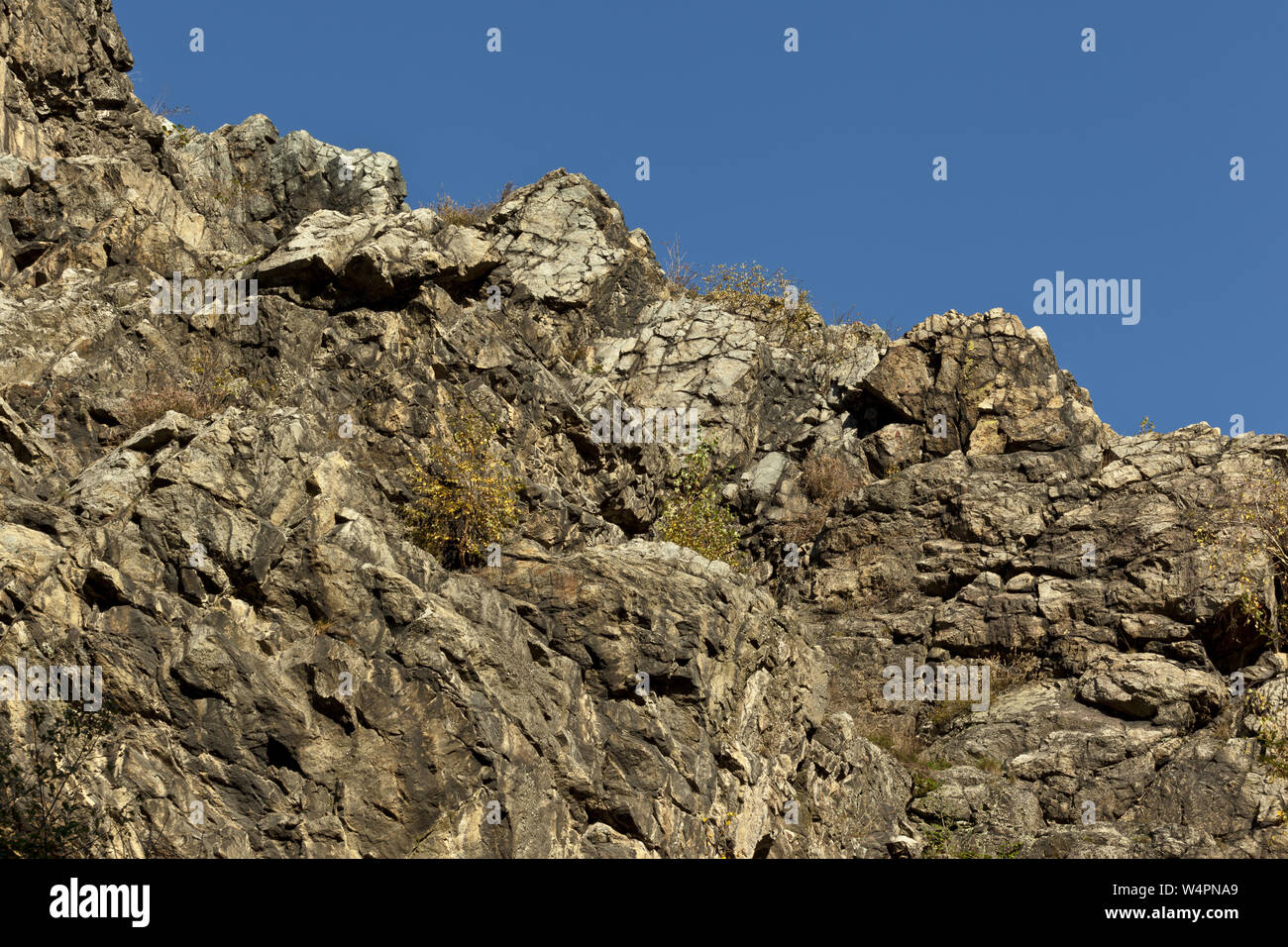 Rock background with blue sky Stock Photo - Alamy