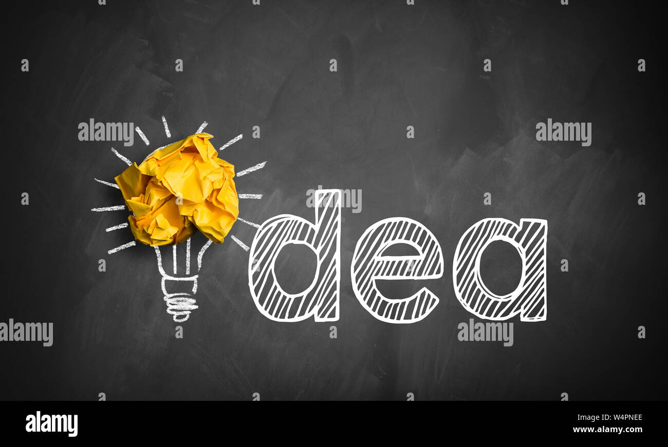 word idea on a blackboard with a lightbulb and crumpled paper as a ...