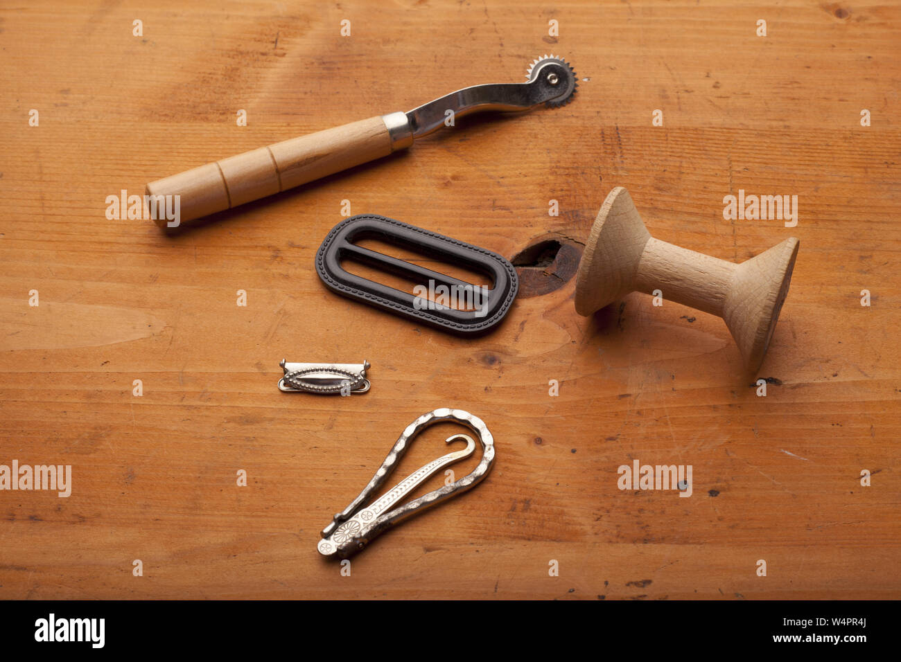 Plow, spool and tailor tools craft concept on wooden texture Stock ...