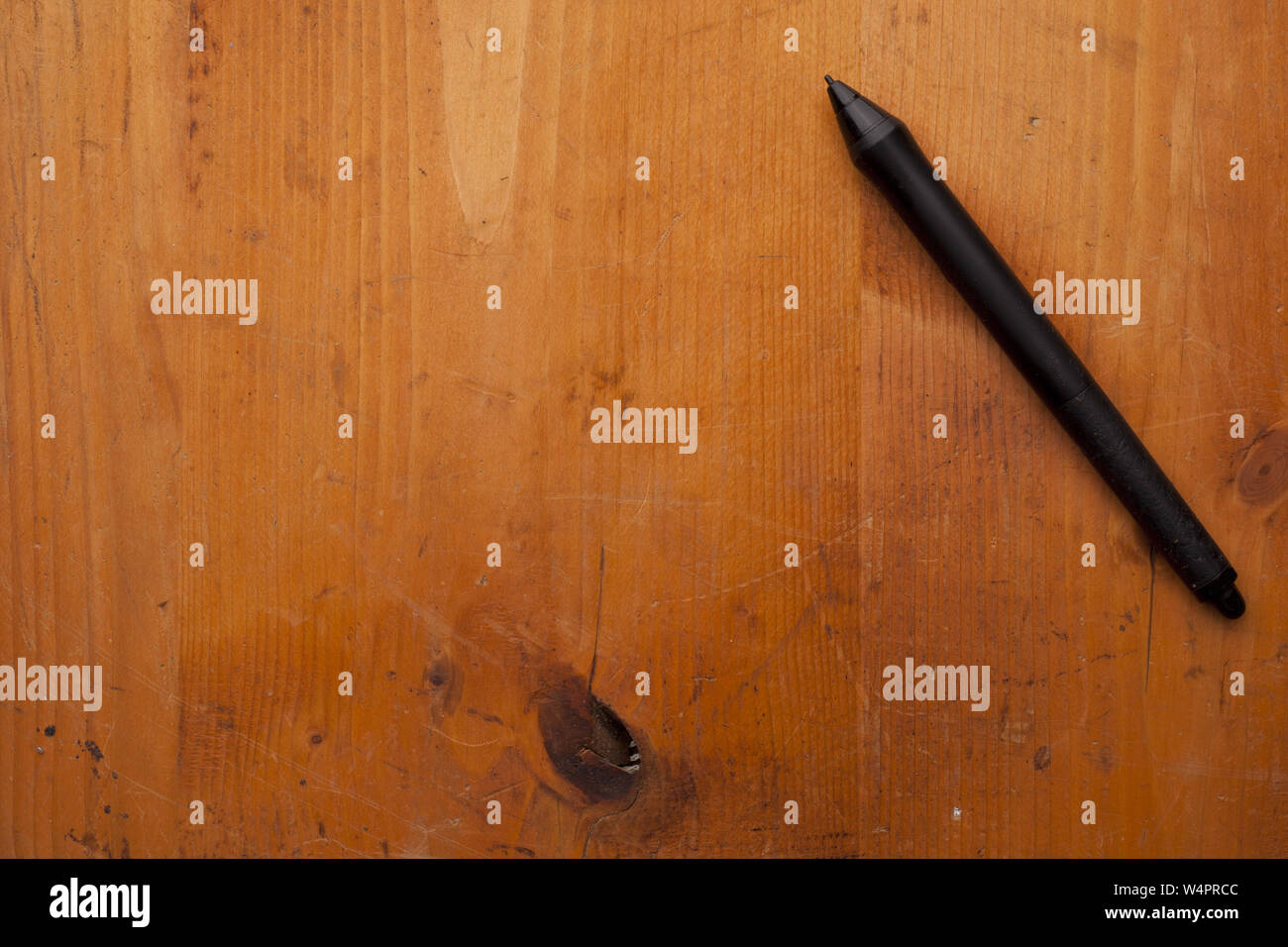 Tablet pen on wood texture, concept Stock Photo - Alamy