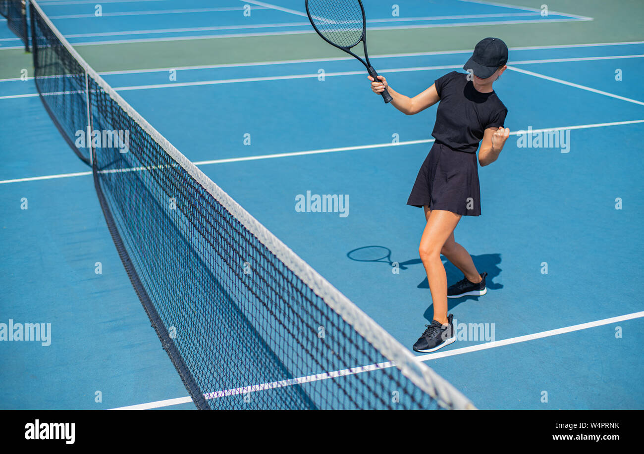 Young tennis player woman celebrating victory in match point. Happy ...