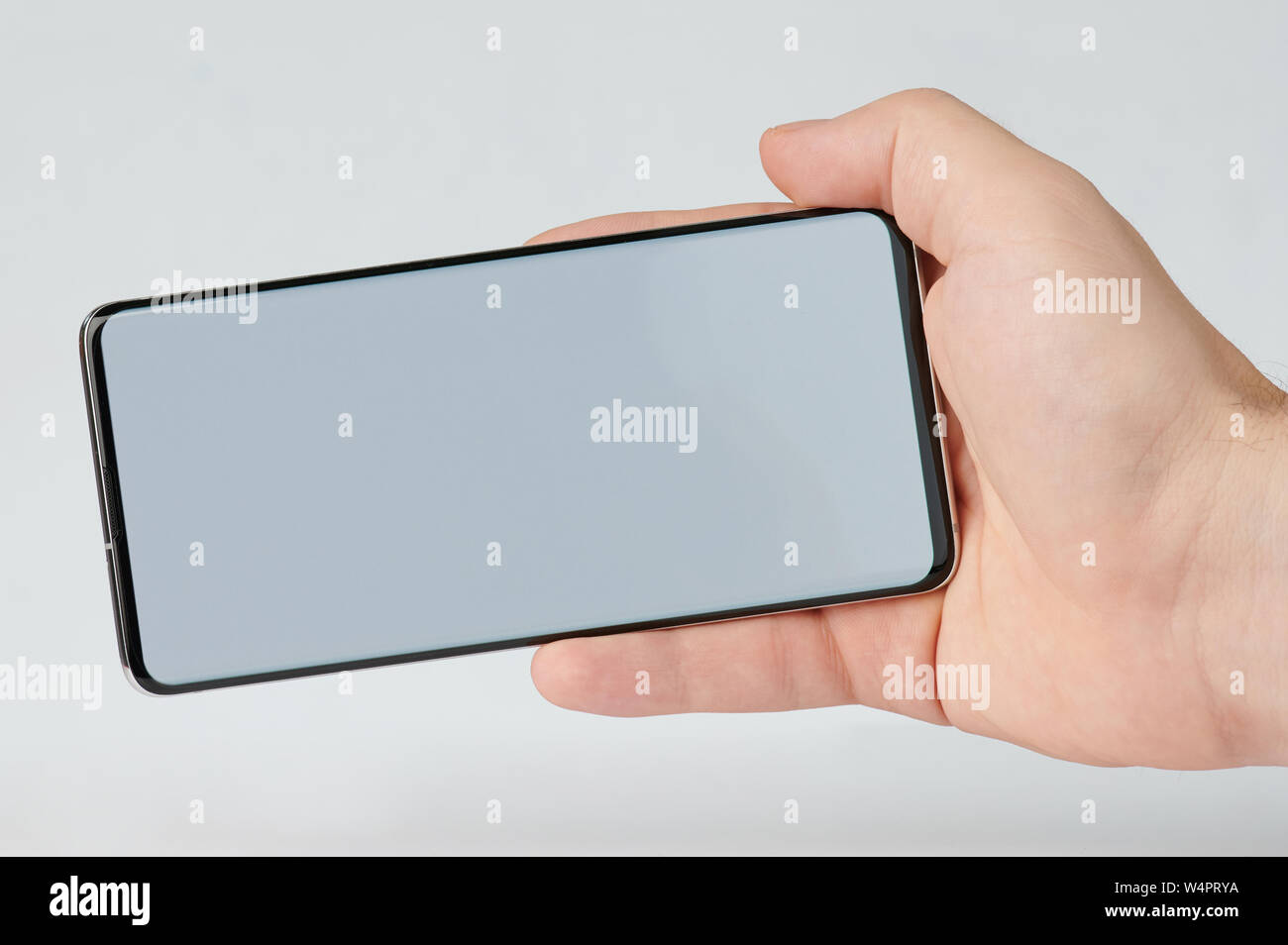 Hand hold smartphone horizontally isolated on white background Stock ...