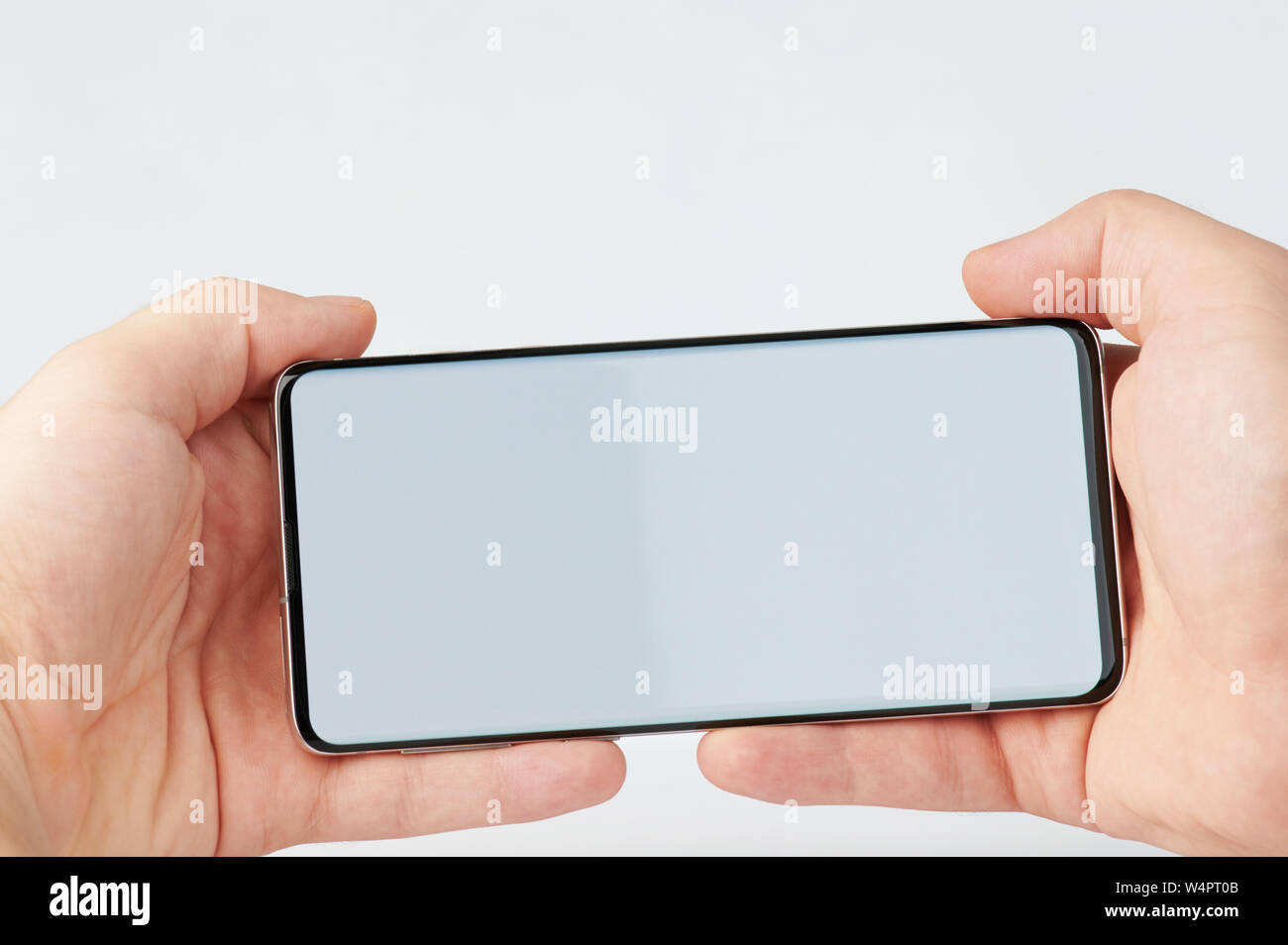 Hands hold smartphone horizontally isolated on white background Stock ...