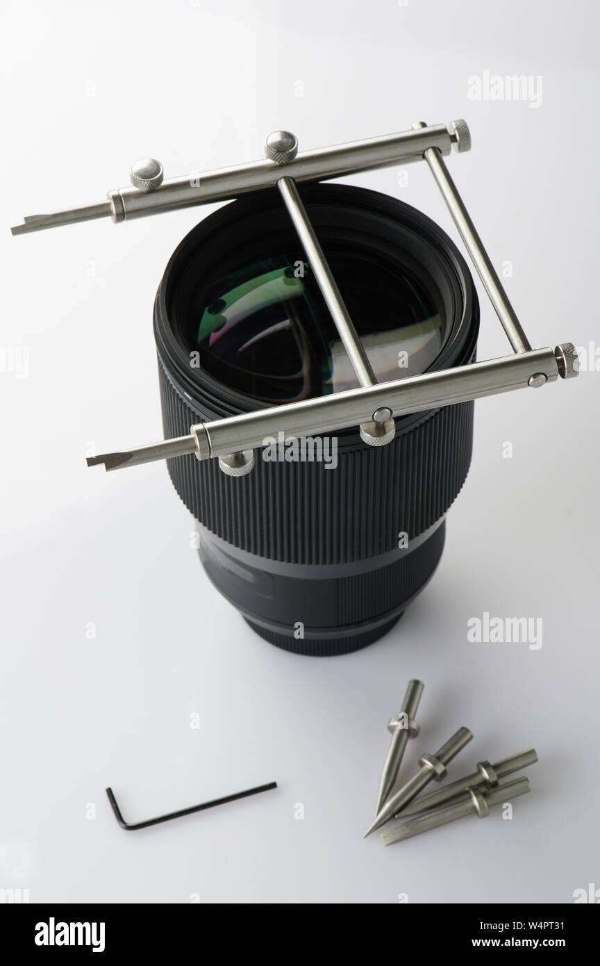 Metal tool on top of big lens isolated on white background Stock Photo ...