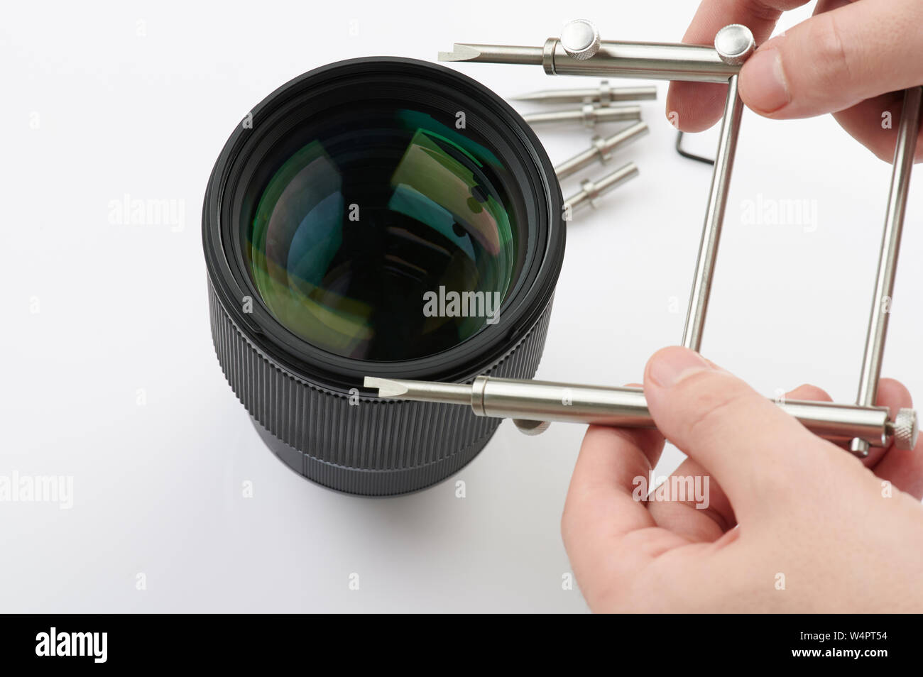Assembling optical lens theme with wrench tool isolated on white ...