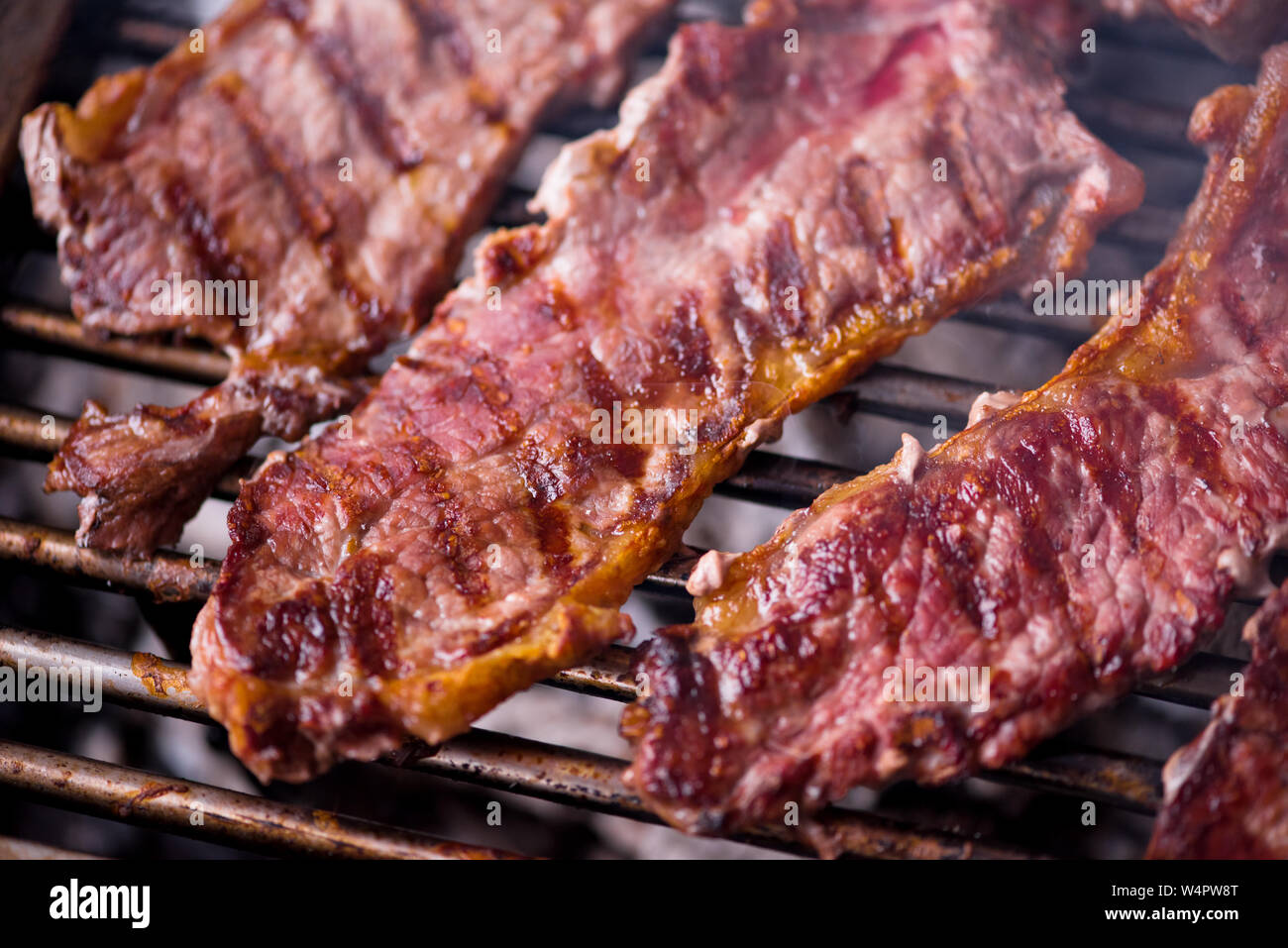Assorted delicious grilled meat over the coals on barbecue Stock Photo ...