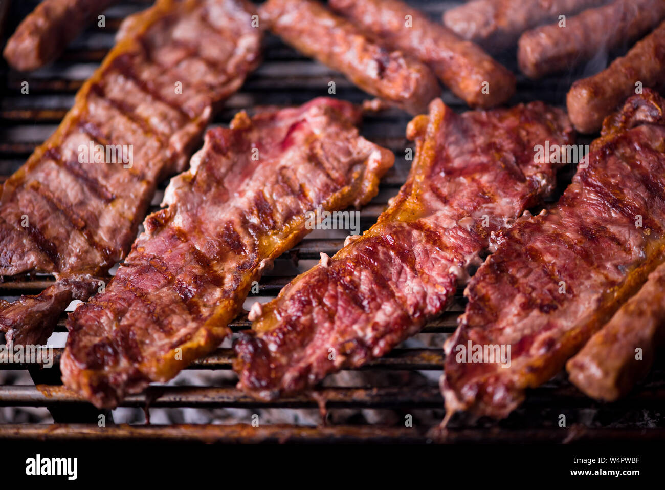 Assorted delicious grilled meat over the coals on barbecue Stock Photo ...