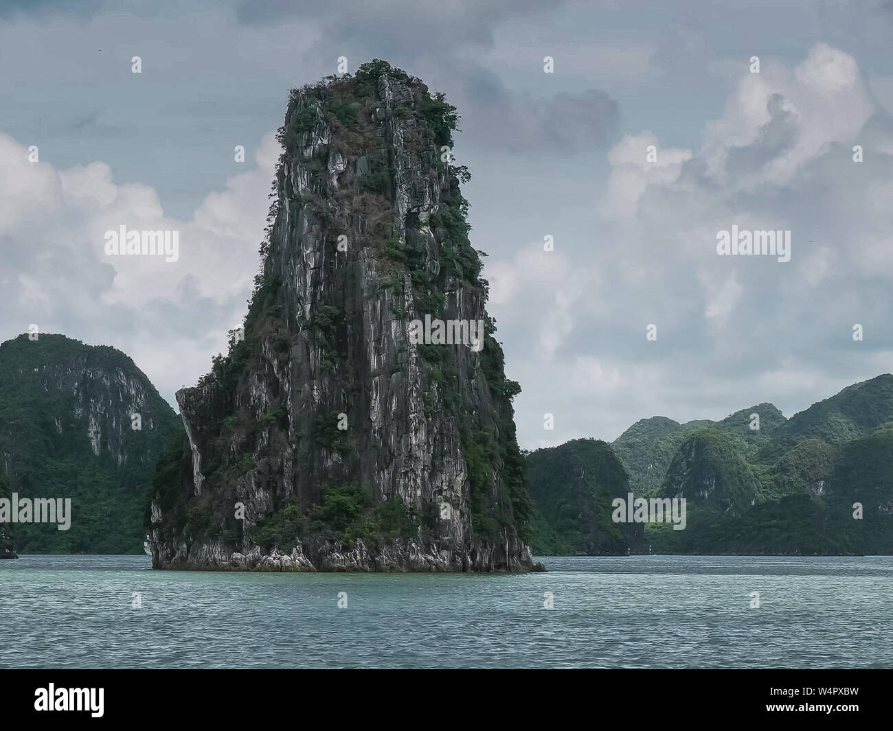 triangular shaped islet at halong bay, vietnam Stock Photo - Alamy