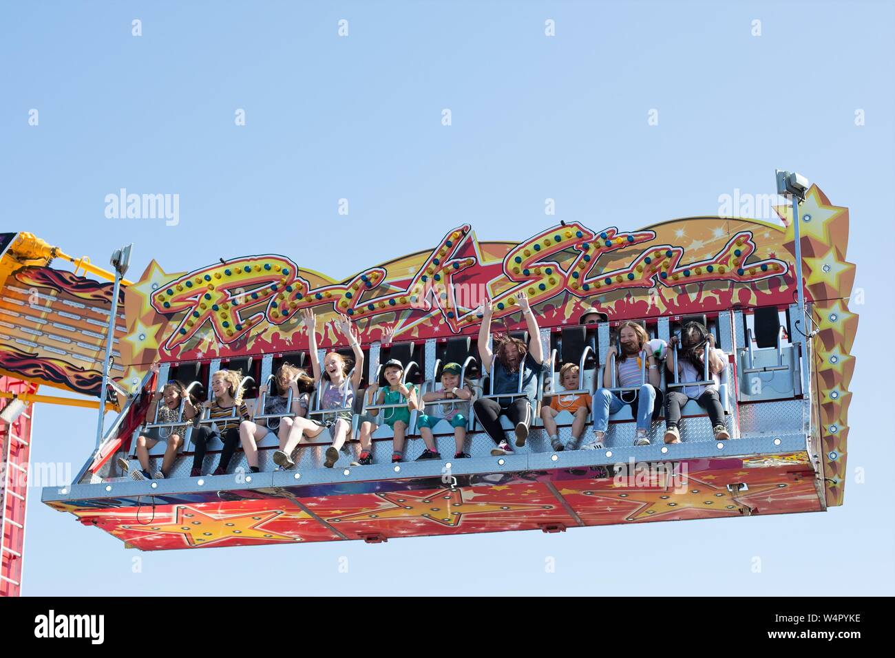 People riding an amusement park ride at a county fair in Oregon, USA ...