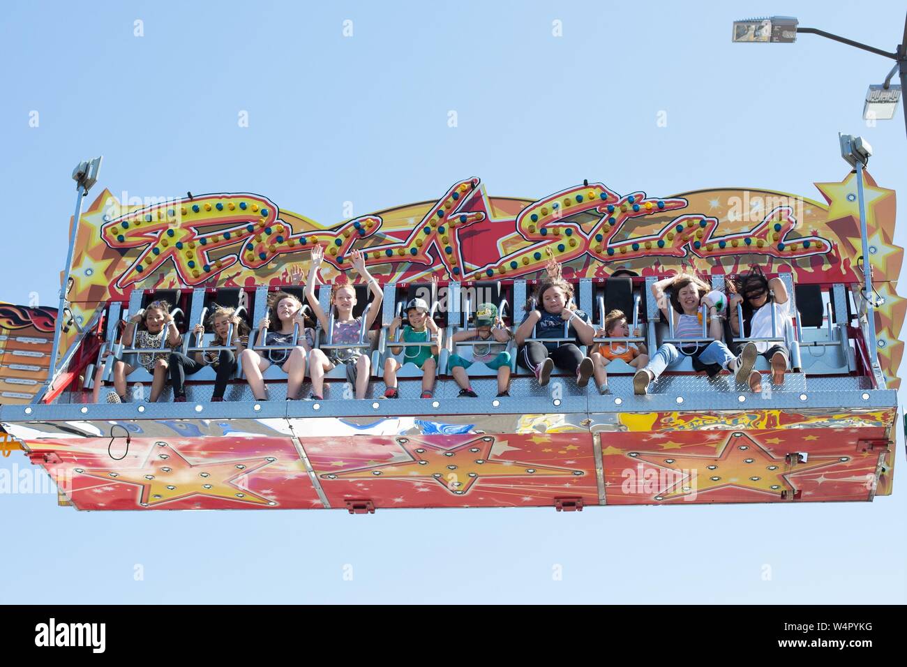 People riding an amusement park ride at a county fair in Oregon, USA ...