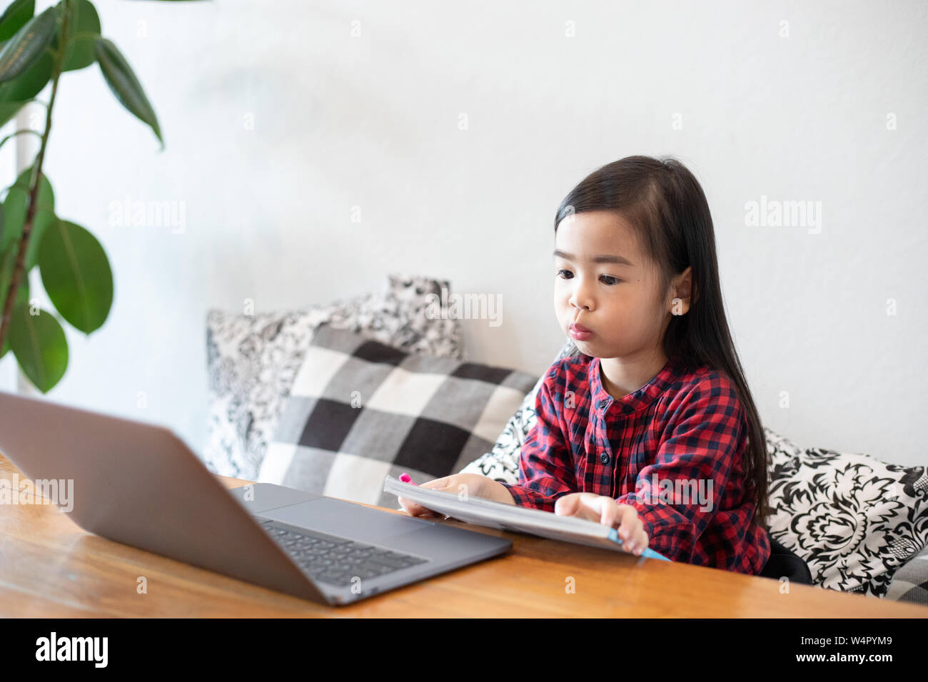 Children read a book and watching notebook Stock Photo - Alamy