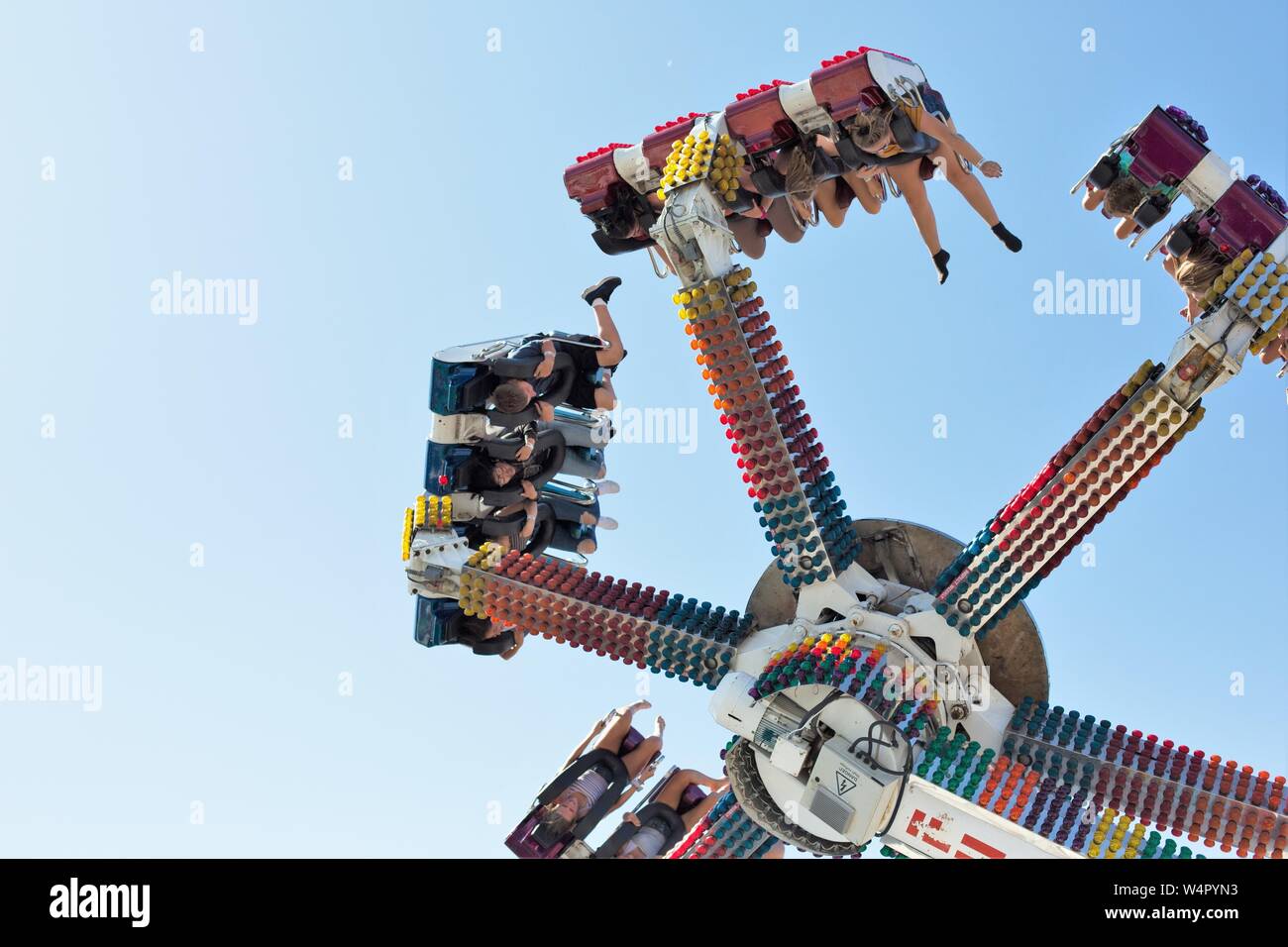 People riding an amusement park ride at a county fair in Oregon, USA ...
