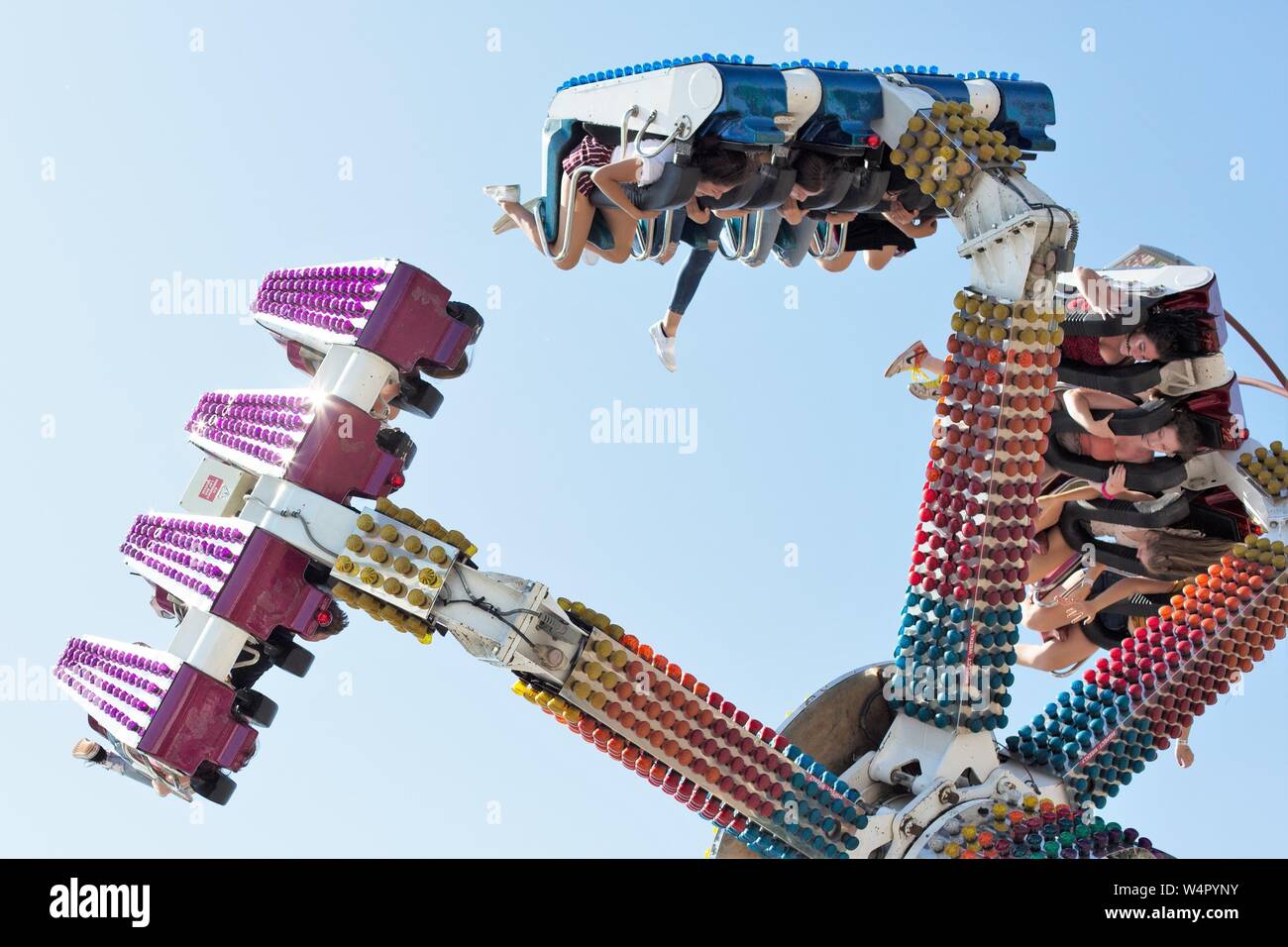 People riding an amusement park ride at a county fair in Oregon, USA ...