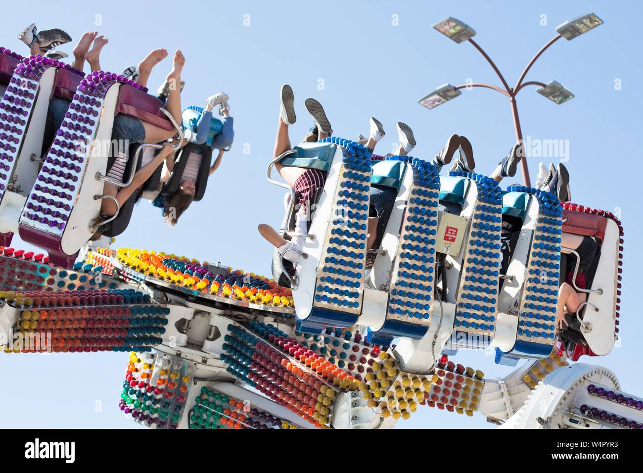 People riding an amusement park ride at a county fair in Oregon, USA ...