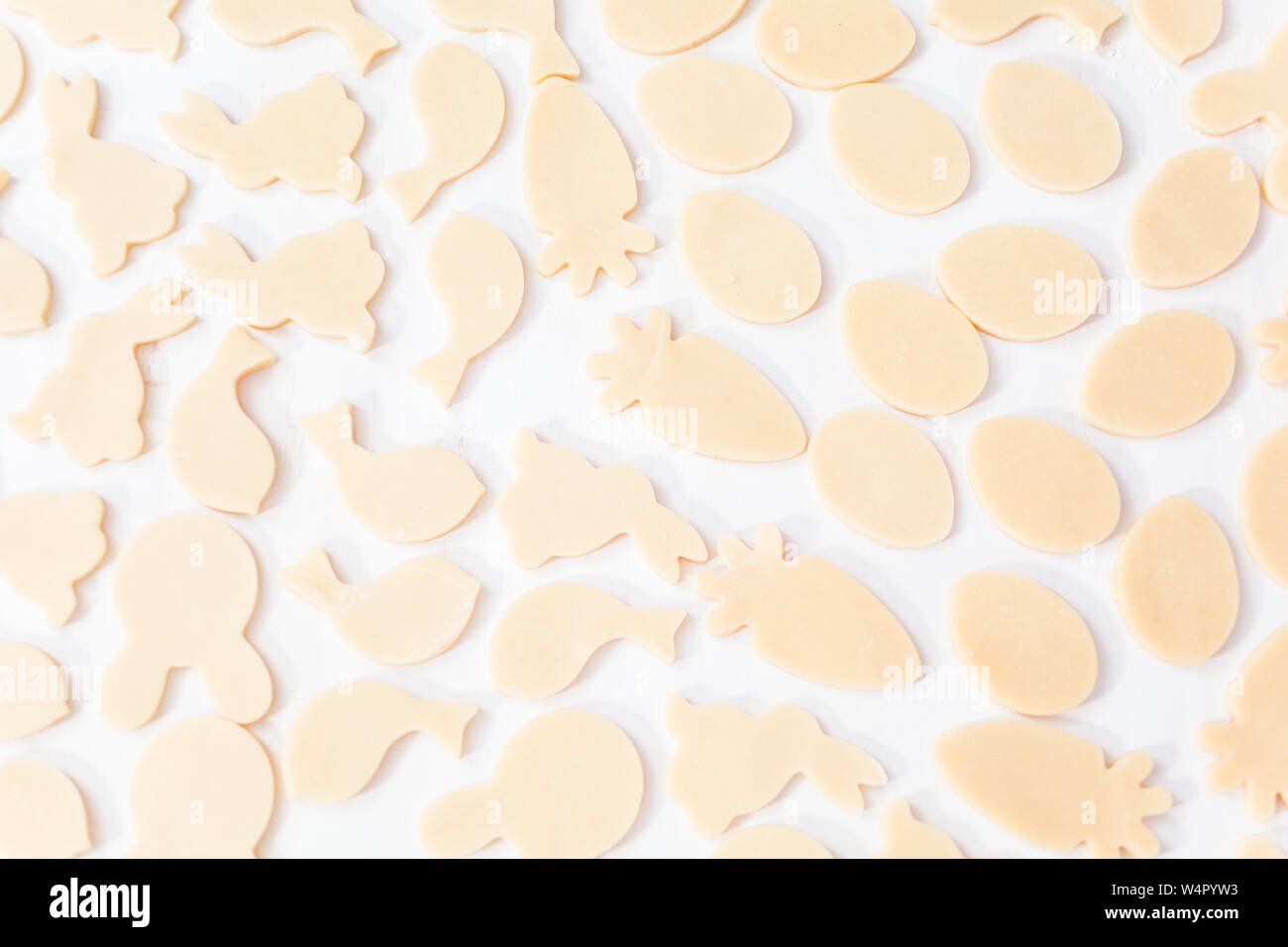 Flat lay. Unbaked Easter sugar cookies on a white table Stock Photo - Alamy