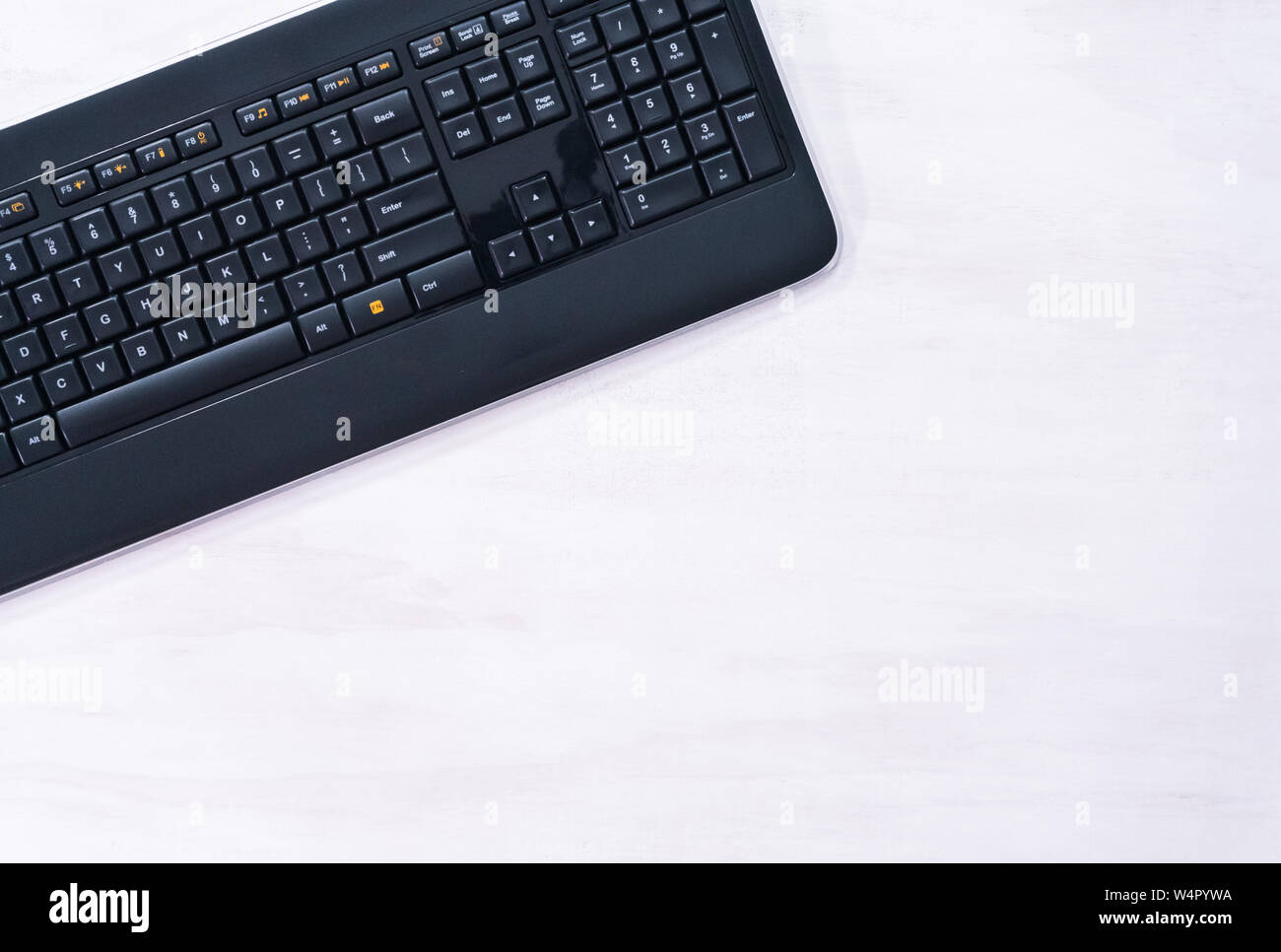 Flat lay. Black computer keyboard on a white table Stock Photo - Alamy