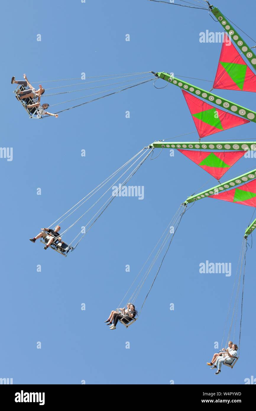 People riding an amusement park ride at a county fair in Oregon, USA ...