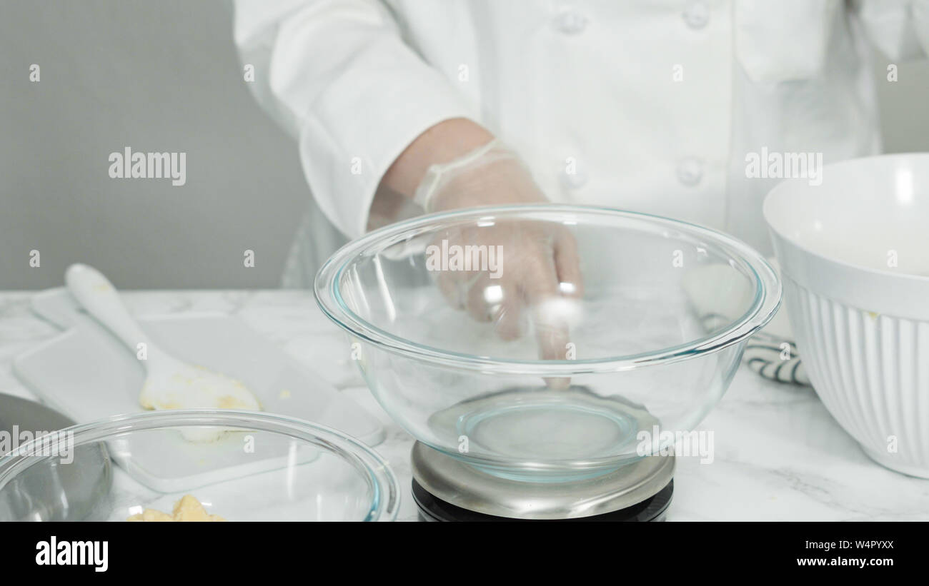 Step by step. Measuring cookie dought with a digital kitchen scale to ...