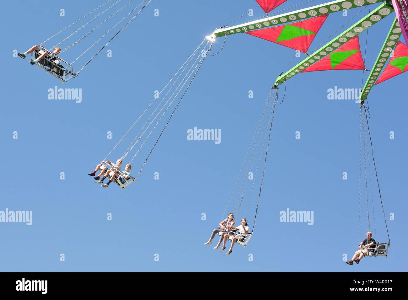 People riding an amusement park ride at a county fair in Oregon, USA ...