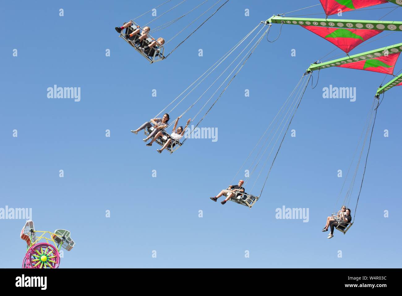 People riding an amusement park ride at a county fair in Oregon, USA ...