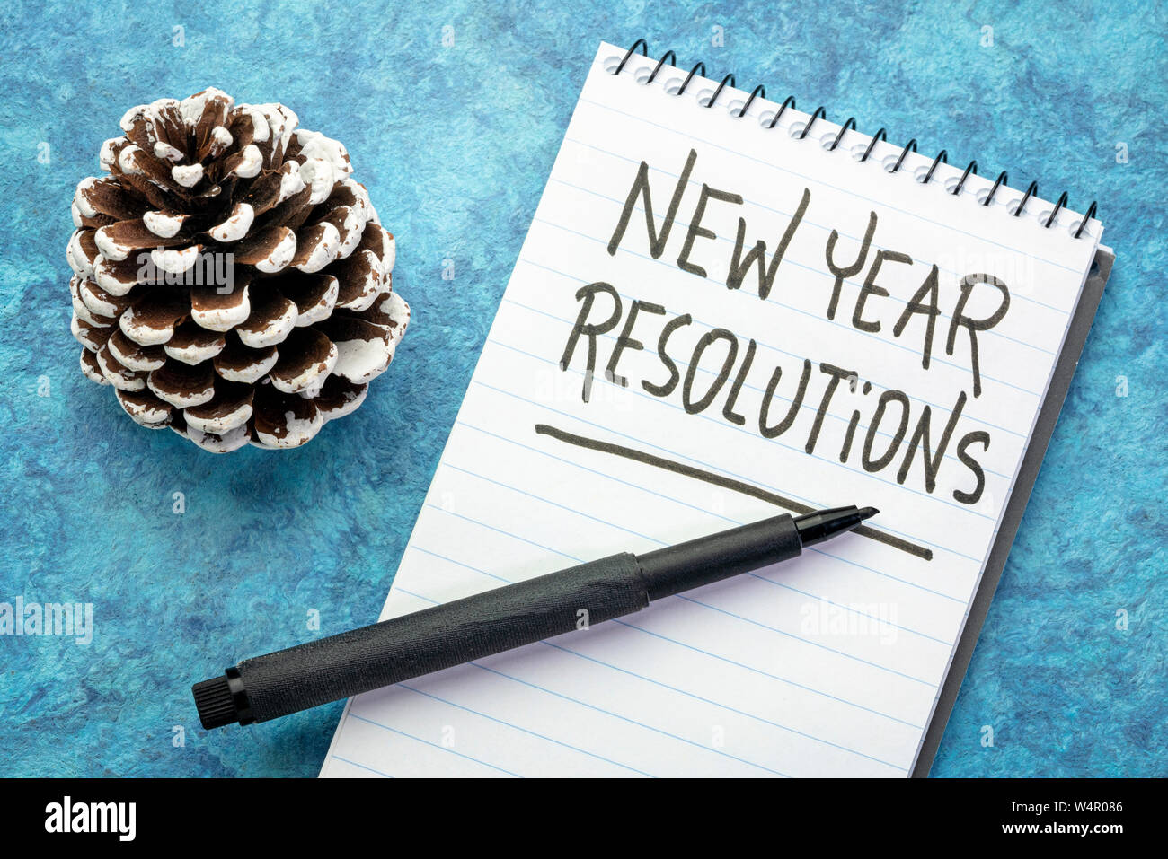 New Year resolutions - handwriting in a spiral notebook with a frosty ...