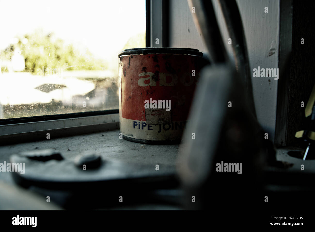 Little corner of a tool shed. Rusty old school can surrounded by ...