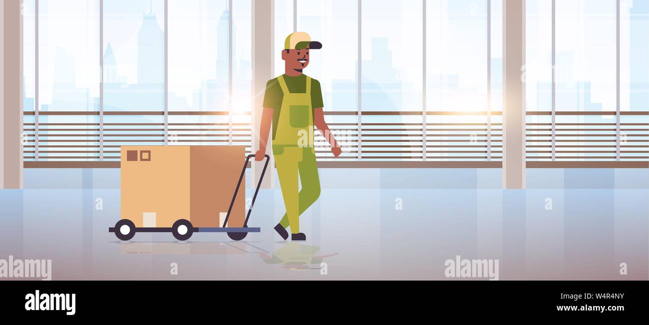 courier in uniform pushing trolley with cardboard box express delivery ...