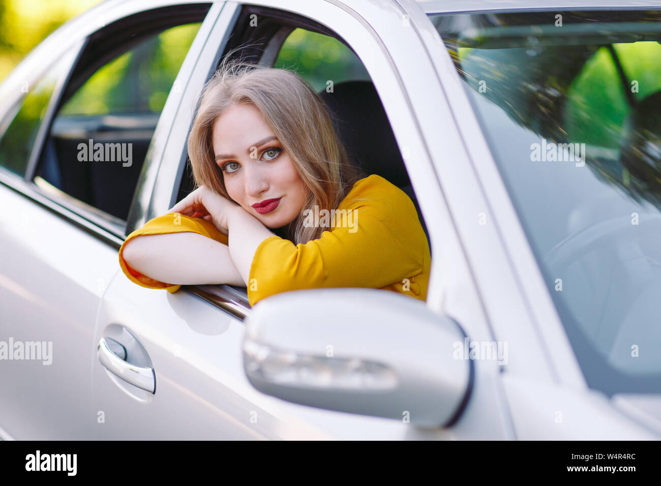 A young beutiful girl is driving a car Stock Photo - Alamy
