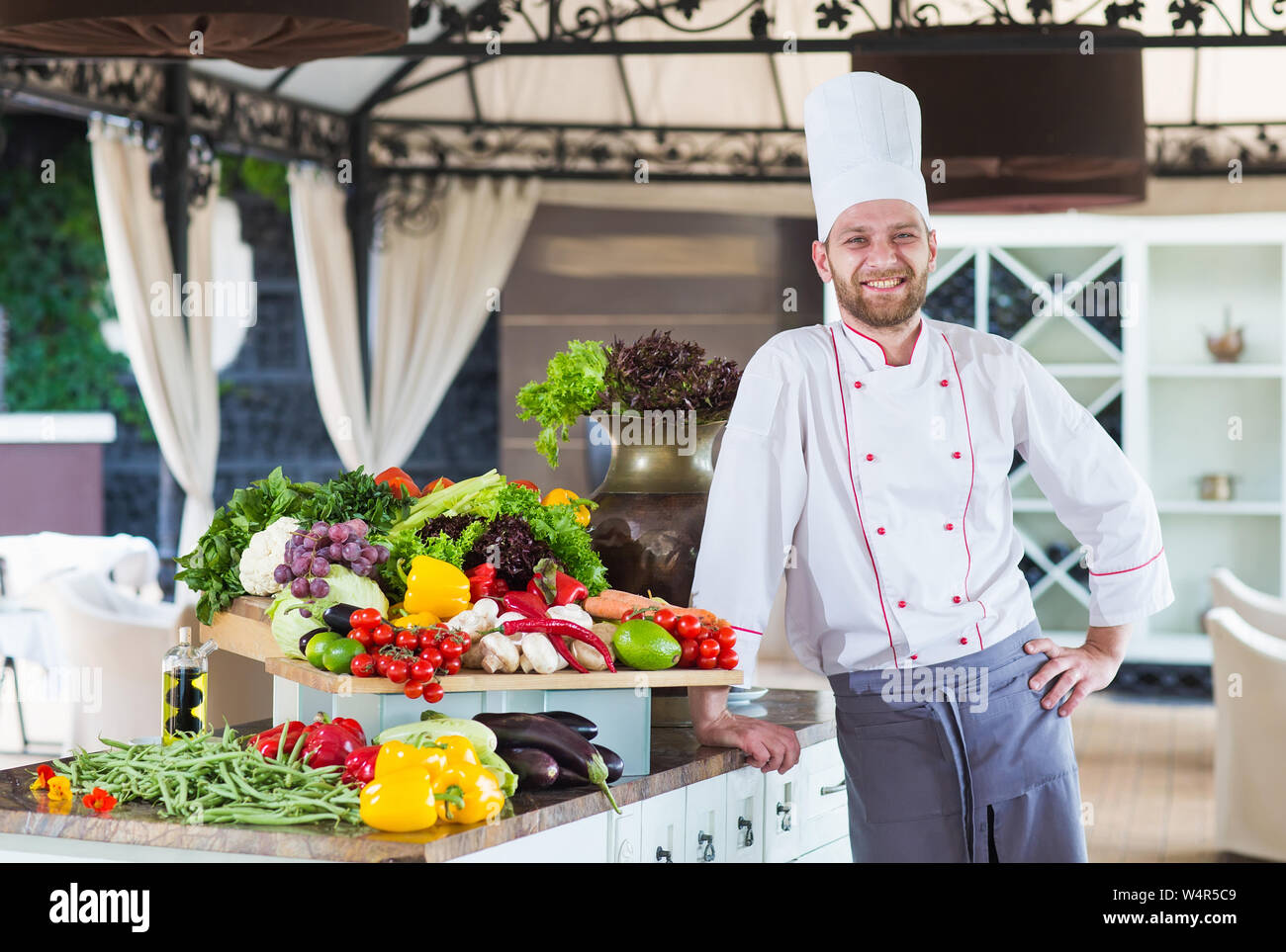 Portrait of a Chef with vegetables in a restaurant Stock Photo - Alamy