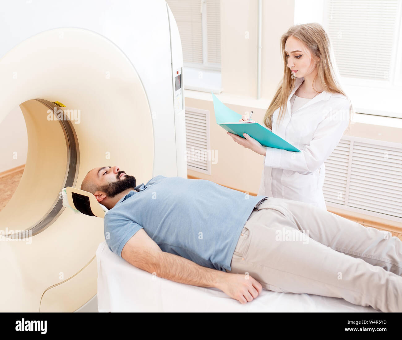 Happy patient undergoing mri scan at hospital Stock Photo - Alamy