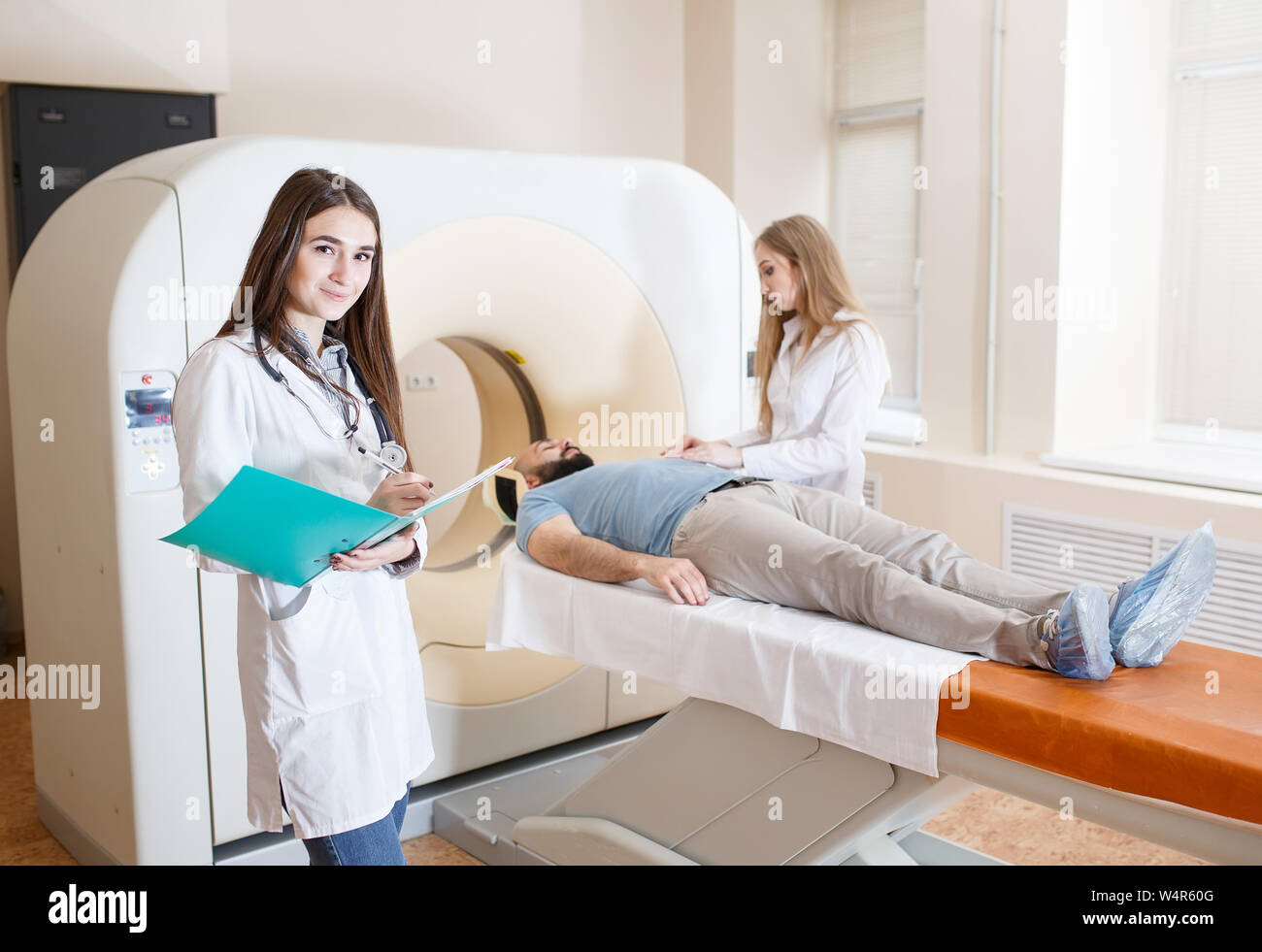 Happy patient undergoing mri scan at hospital Stock Photo - Alamy