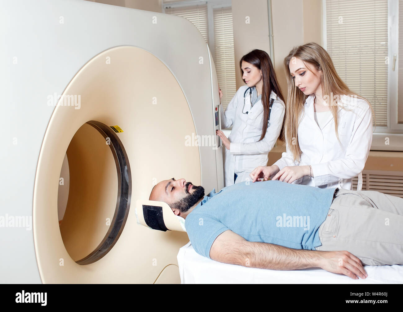 Happy patient undergoing mri scan at hospital Stock Photo - Alamy