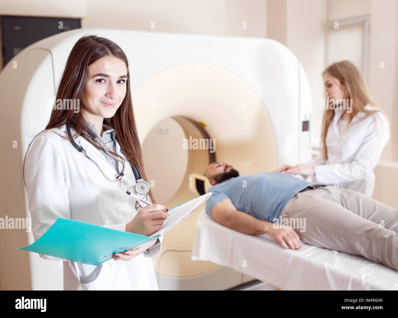 Happy patient undergoing mri scan at hospital Stock Photo - Alamy