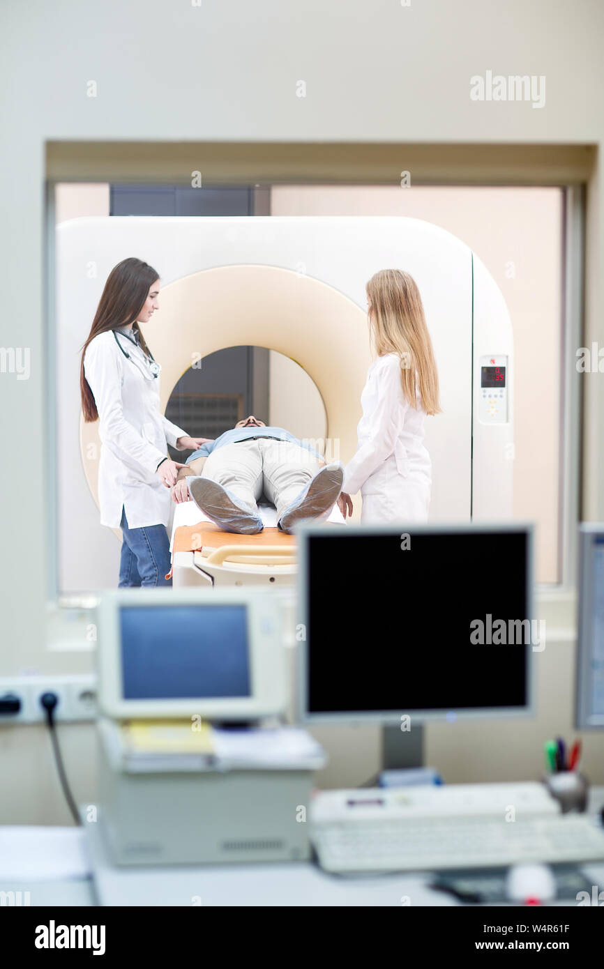 MRI machine and screens with doctor and nurse Stock Photo - Alamy