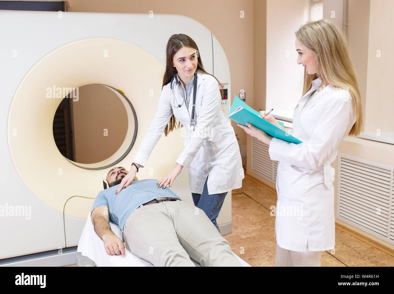 Happy patient undergoing mri scan at hospital Stock Photo - Alamy