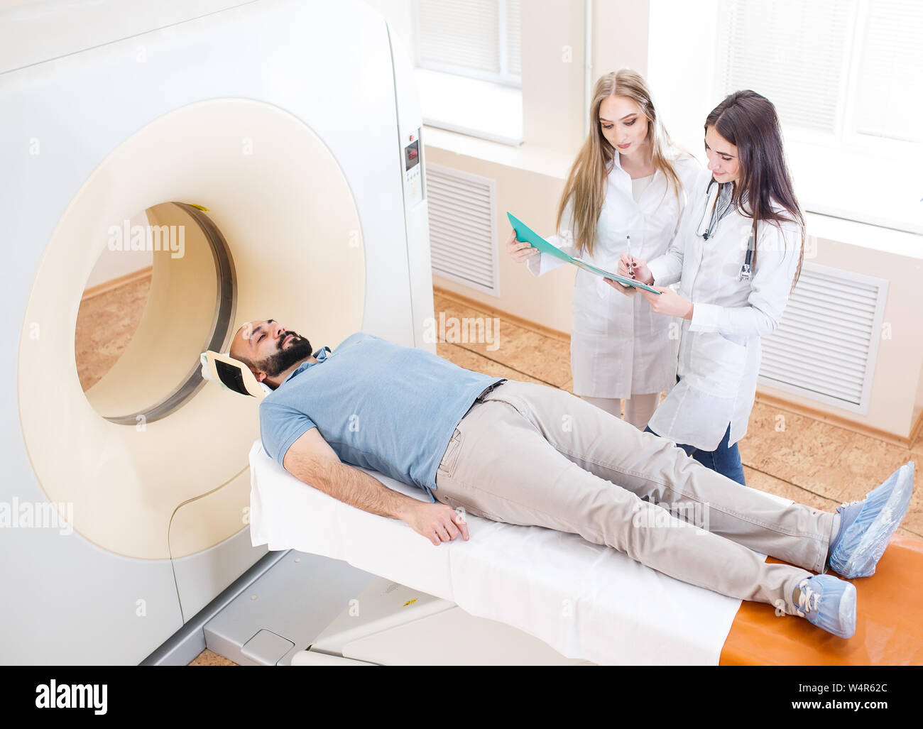 Happy patient undergoing mri scan at hospital Stock Photo - Alamy
